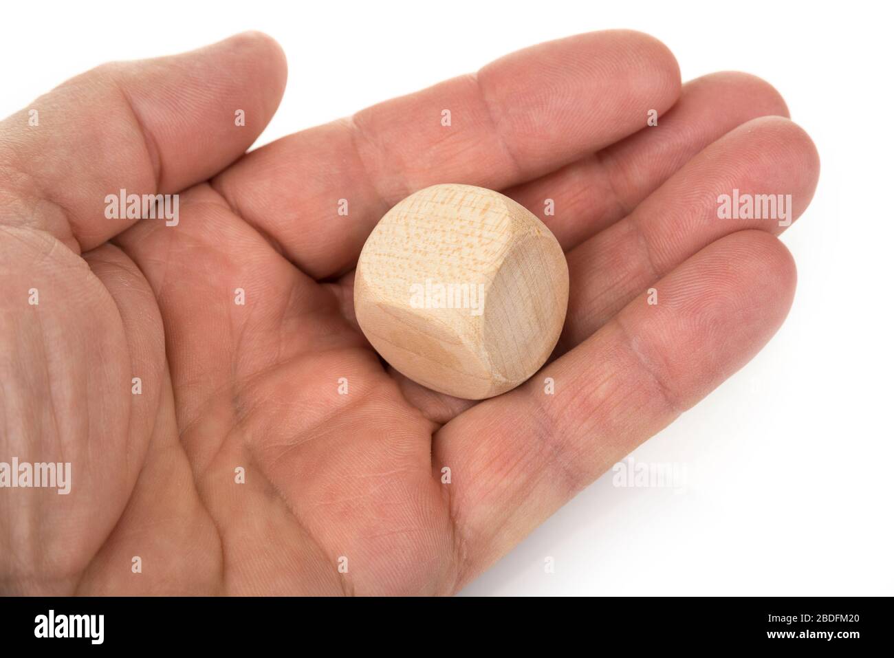 Wooden dice in the hand on a white background Stock Photo - Alamy