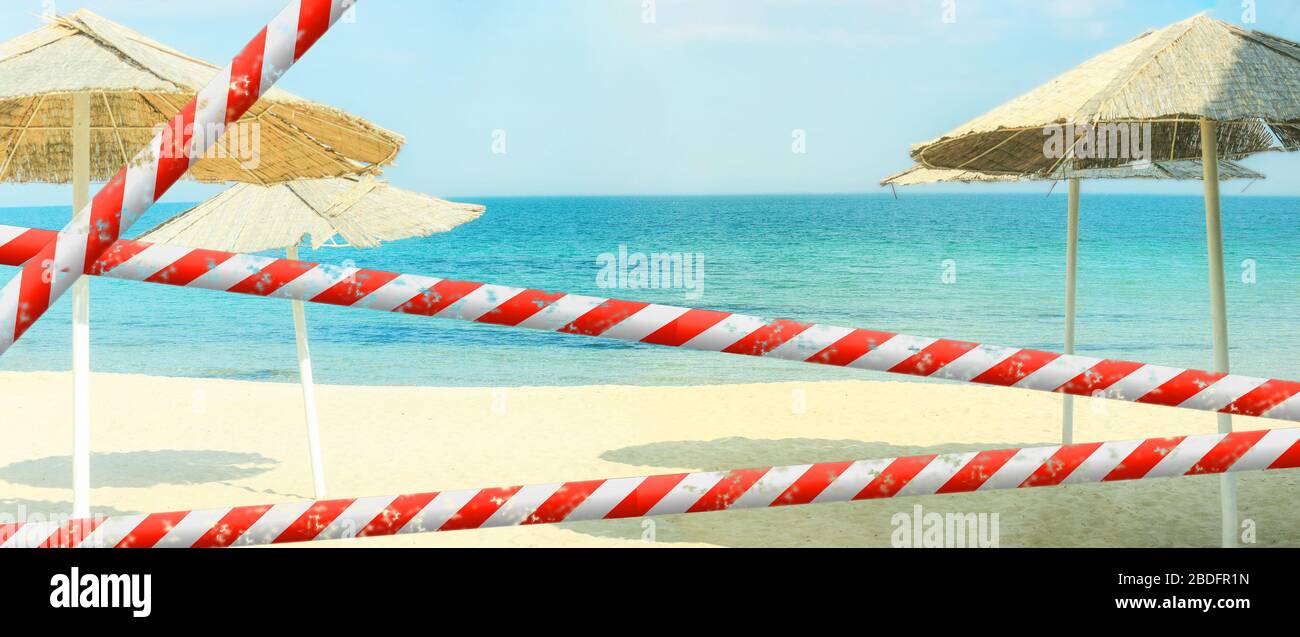 Beach is closed with a red barrier tape on a blurred background ...