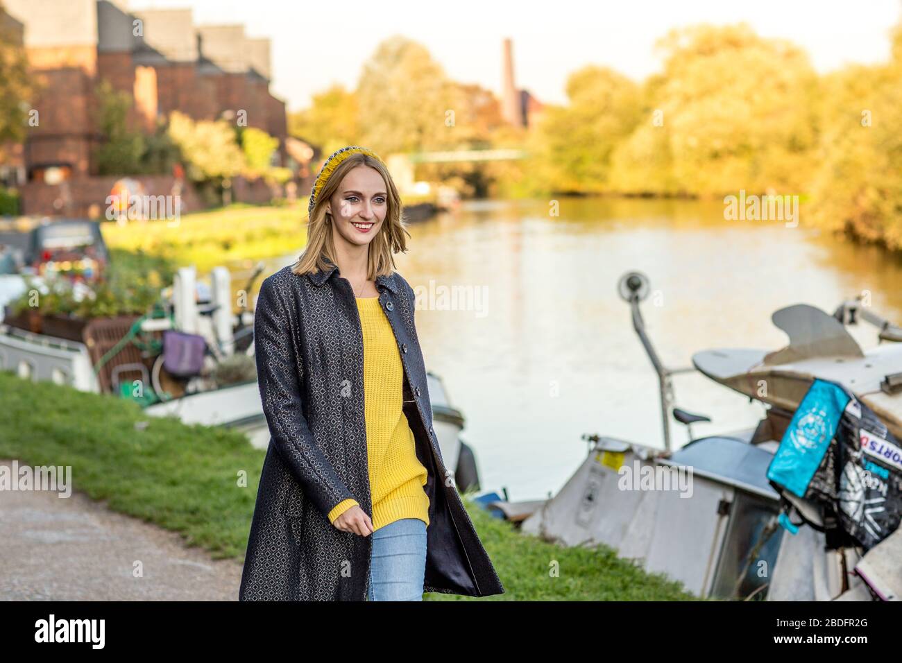 young woman enjoying a walk along the river Stock Photo - Alamy