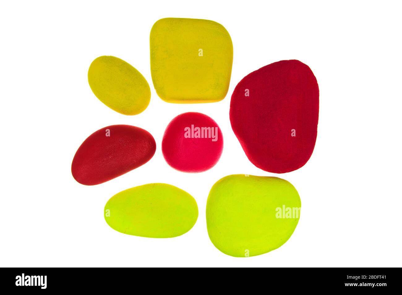 Group of multi coloured painted stones isolated on a white background ...