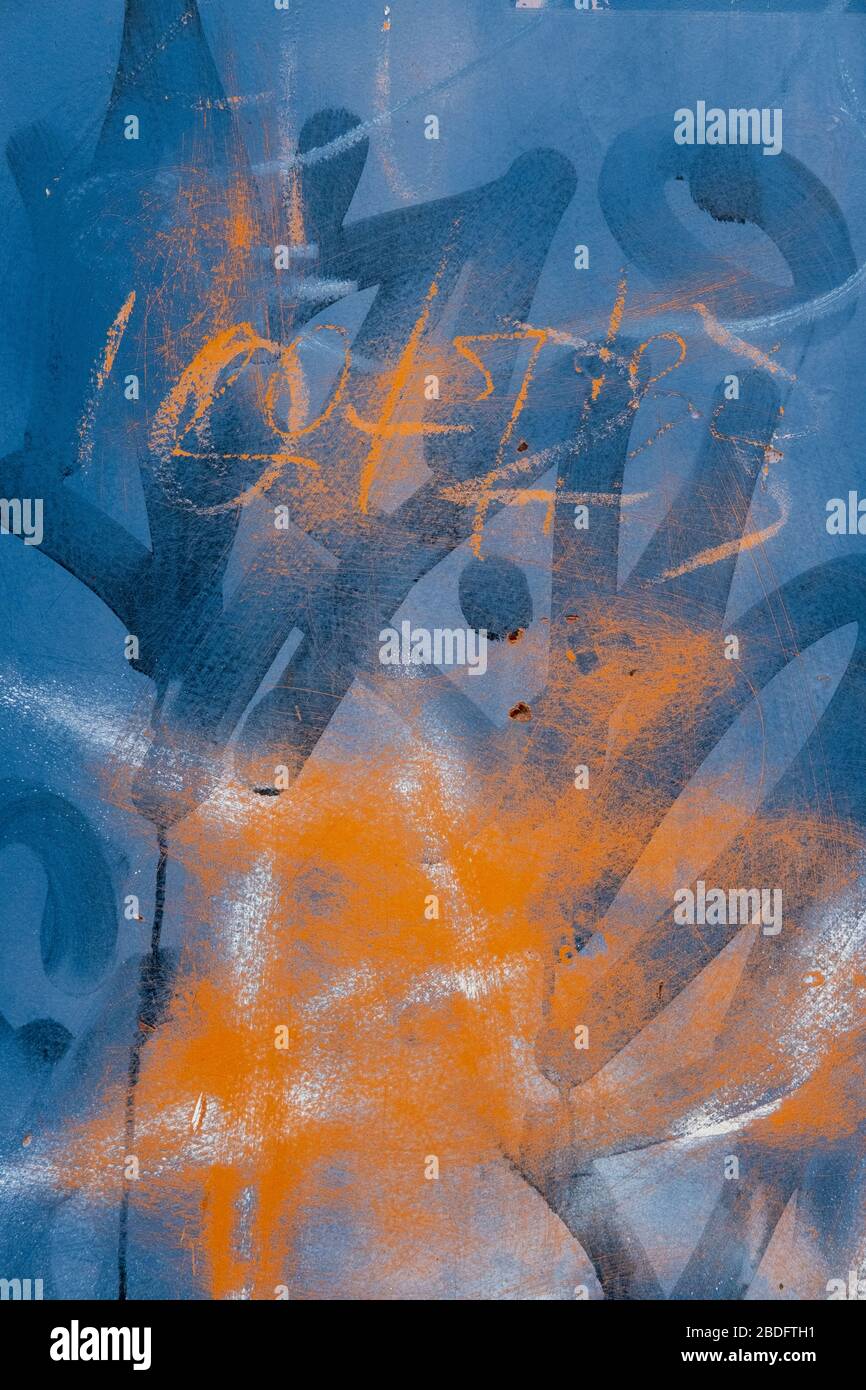 Detail of peeling paint and markings on colorfully painted industrial ...