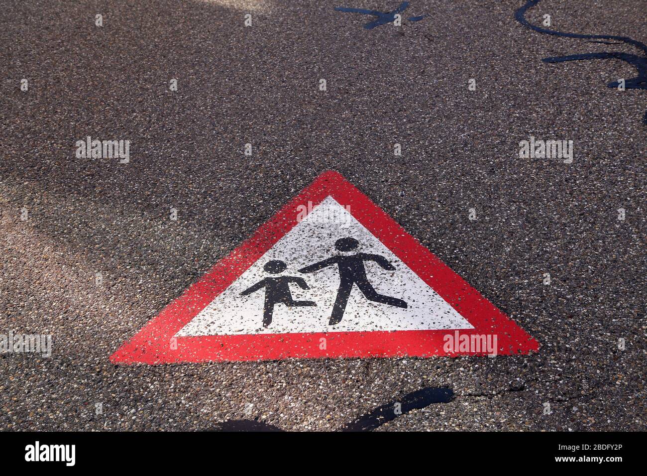 Children on the road, sign painted on the asphalt Stock Photo - Alamy