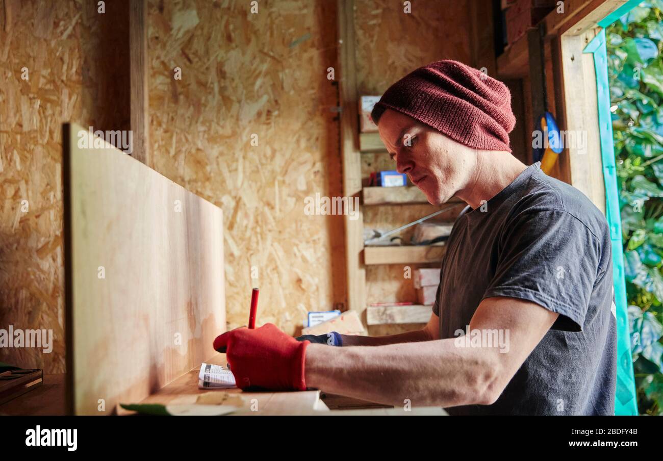 Carpenter working in shed Stock Photo - Alamy