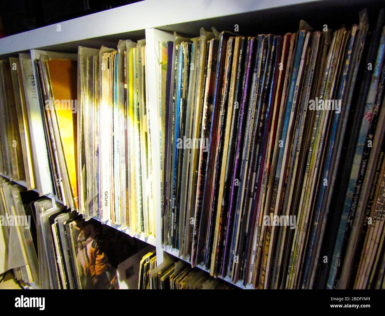 A collection of vinyl records on a shelf at home Stock Photo - Alamy
