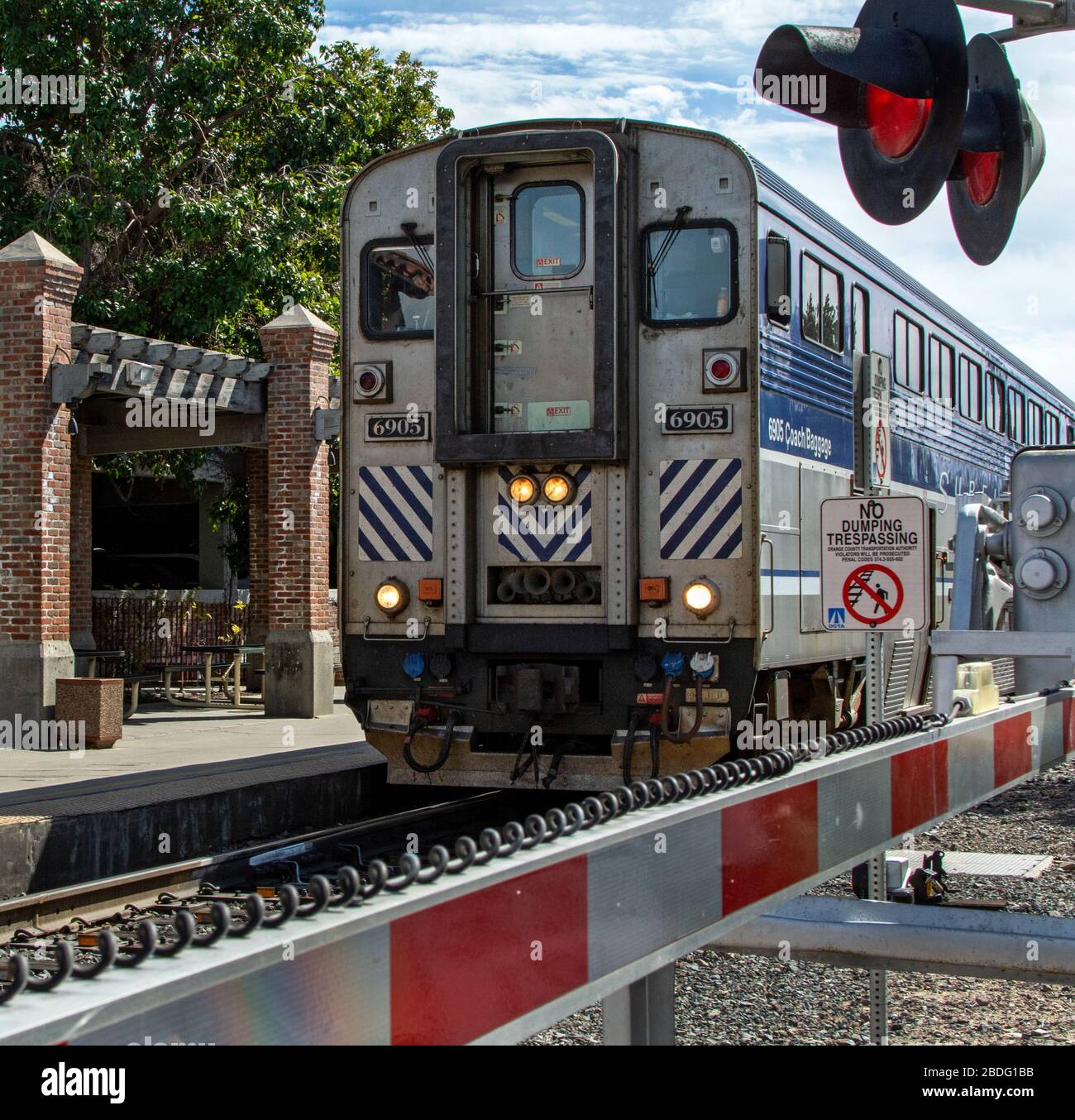 Passenger train coming into a train station Stock Photo - Alamy
