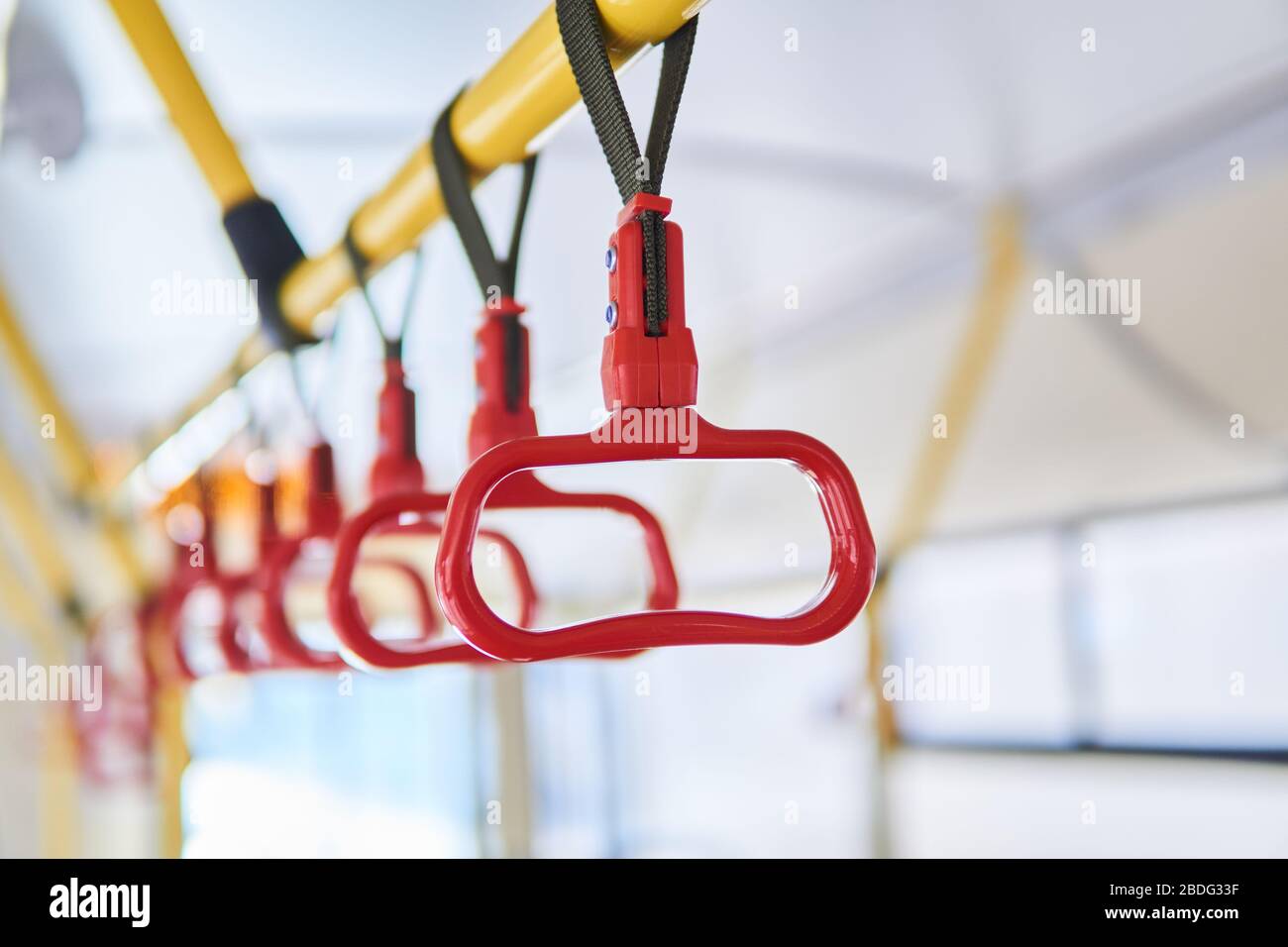 partially blurred grab handles for standing passengers in the passenger ...