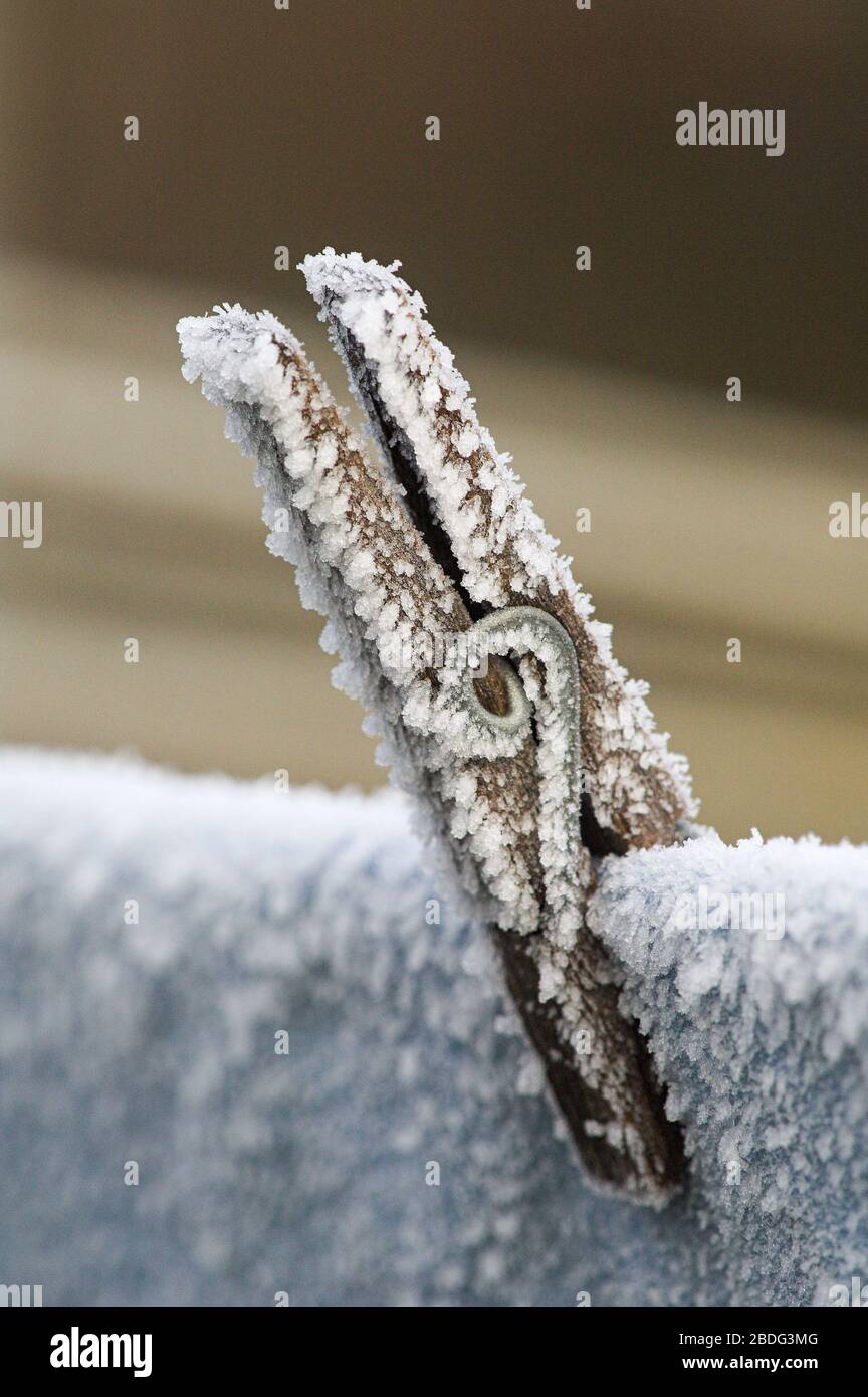 Frozen clothes peg on washing line Stock Photo - Alamy
