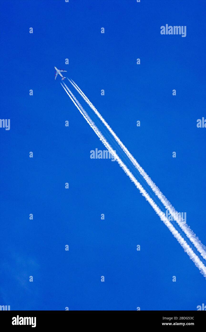 Jet aeroplane contrail clouds high in the atmosphere. Beautiful blue ...