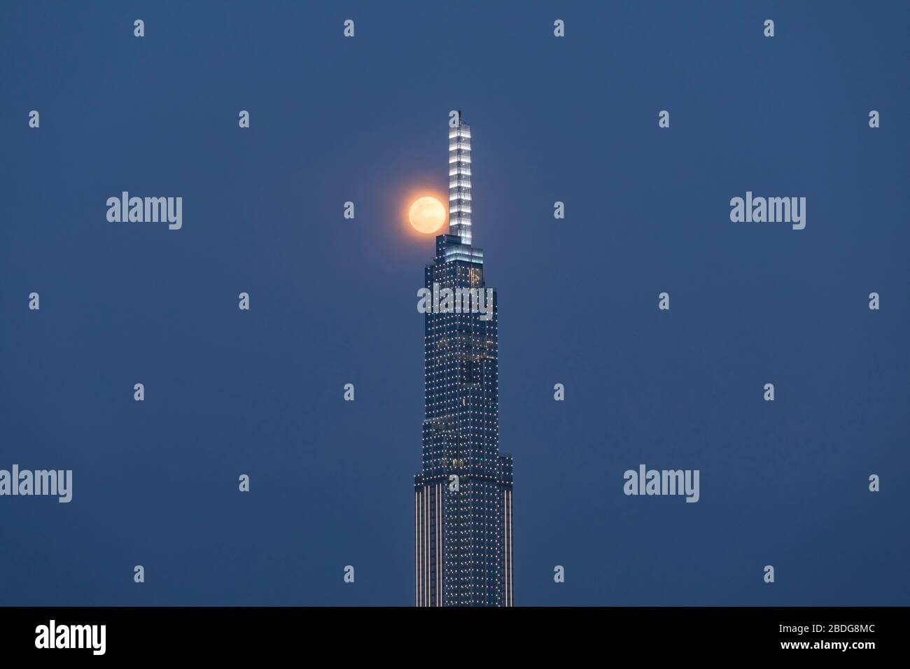 Glowing full Gibbons moon rising alongside the Landmark high rise ...