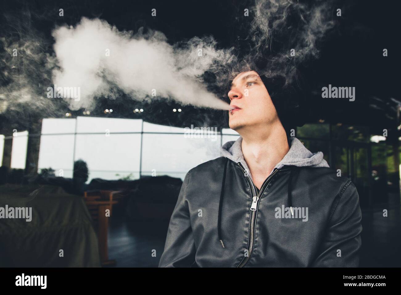 Vape steamer urban youngster casual look in outdoor cafe Stock Photo ...