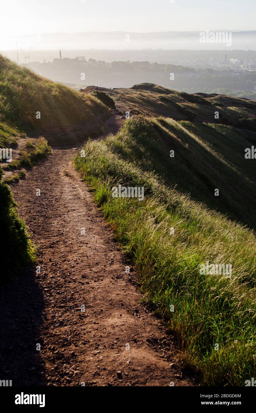 Walking Through Hills at Dusk Stock Photo - Alamy