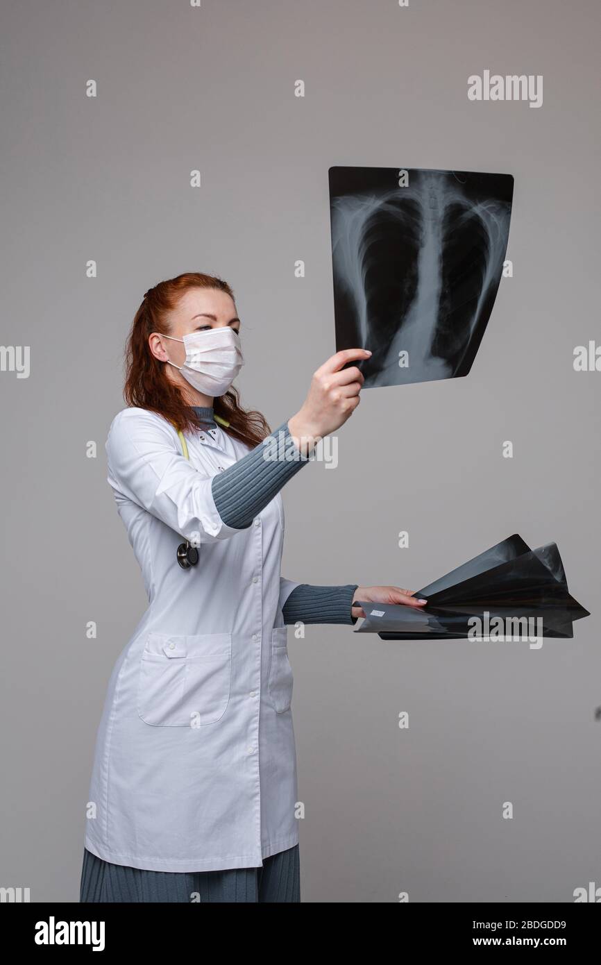 Doctor checking X-RAY photograph. Professional doctor with red hair ...