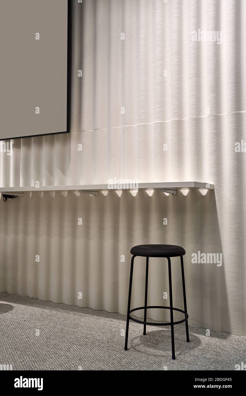 Illuminated room with waved wall and furniture Stock Photo - Alamy