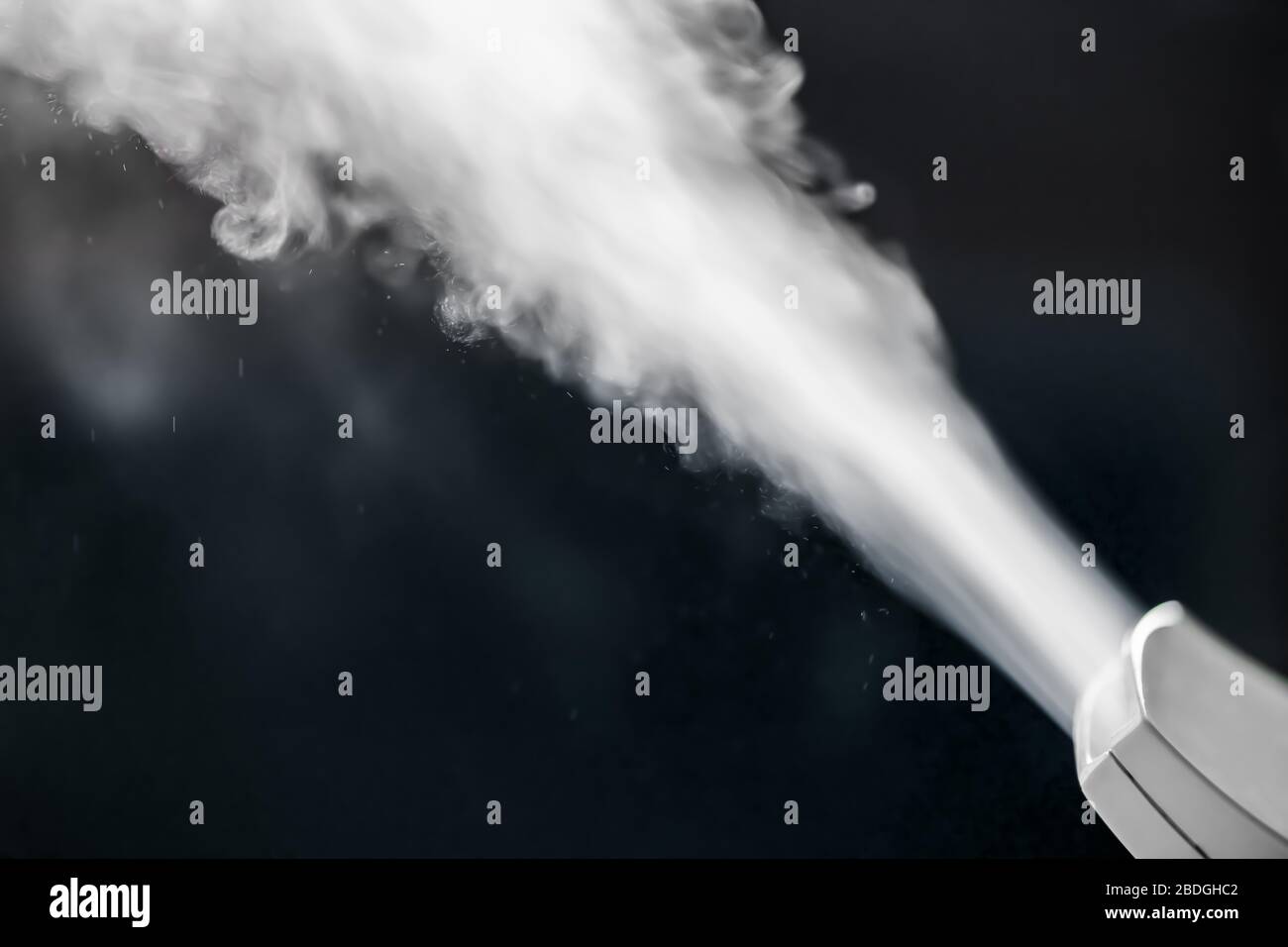 closeup steam from the air humidifier on black background. health ...