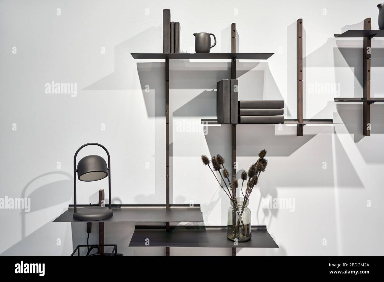 Luminous room with light wall and dark shelves Stock Photo - Alamy
