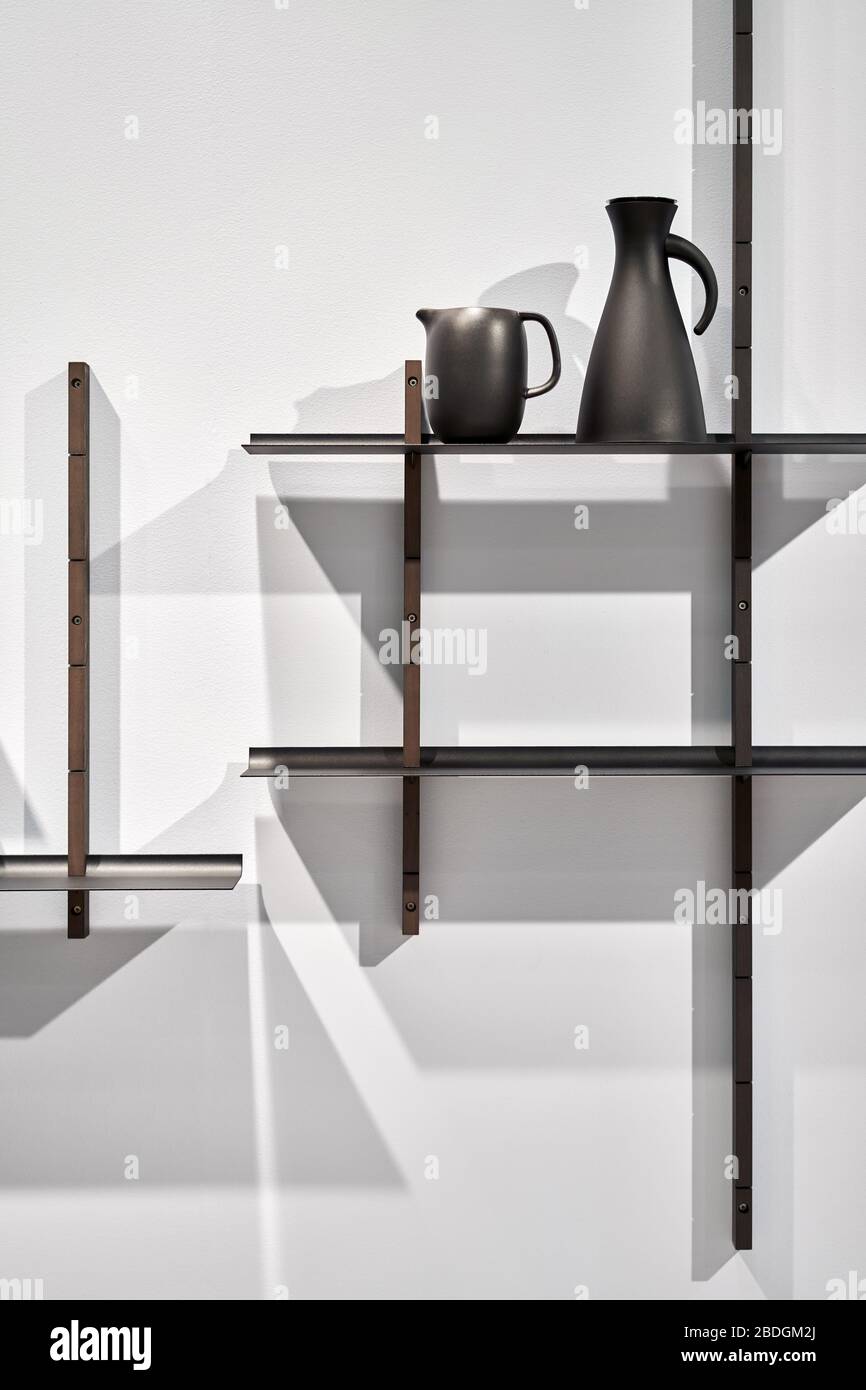 Luminous room with light wall and dark shelves Stock Photo - Alamy