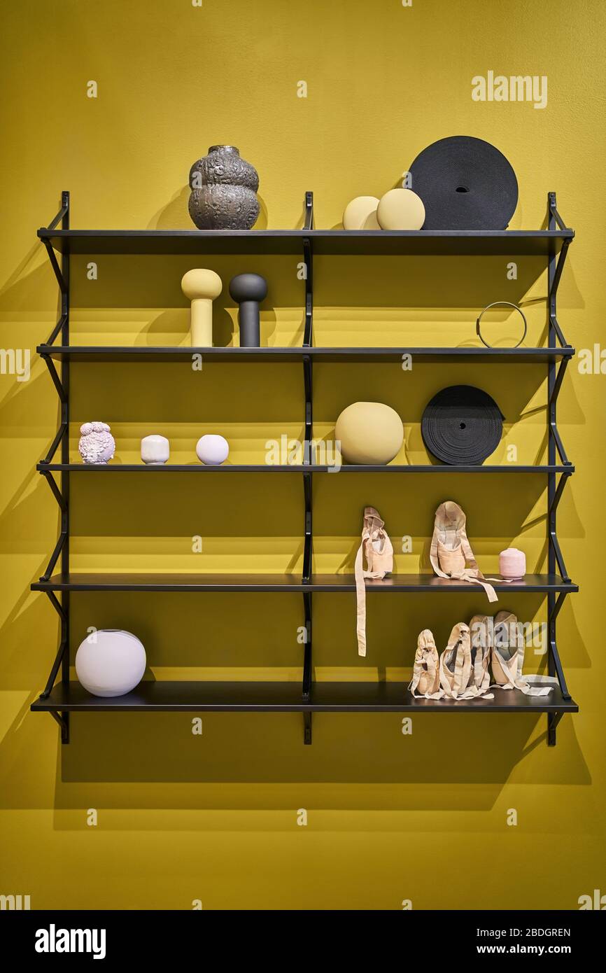 Interior with yellow walls and shelves with decor Stock Photo - Alamy