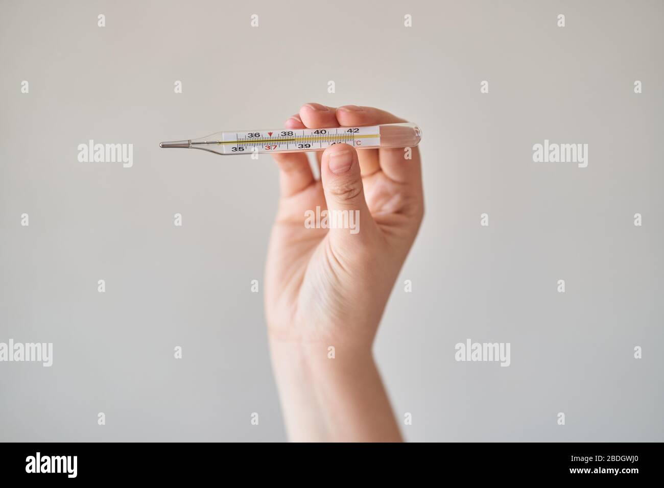 Girl holds a thermometer. High body temperature on a thermometer Stock ...