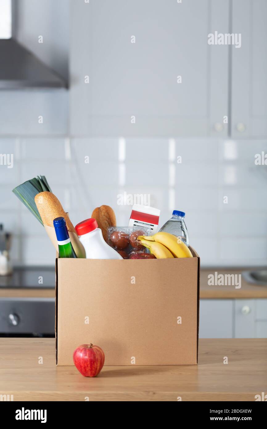 Safe home delivery. A box of different food on the modern kitchen Stock ...