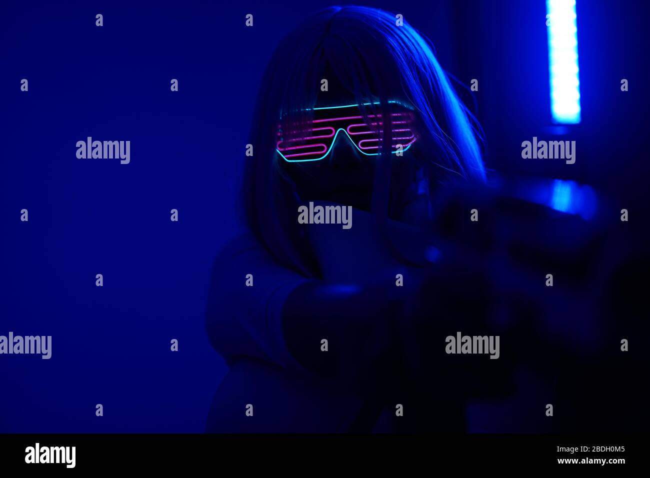 Girl with blaster in the futuristic battle. Concept virtual reality ...