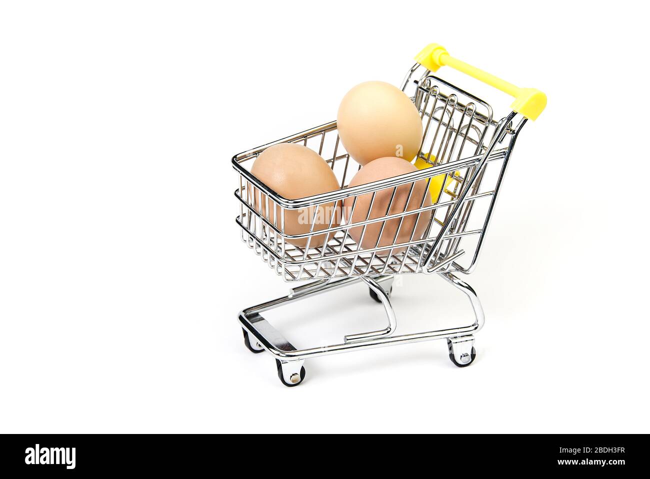 chicken colored eggs in a shopping cart. isolated on white Stock Photo ...