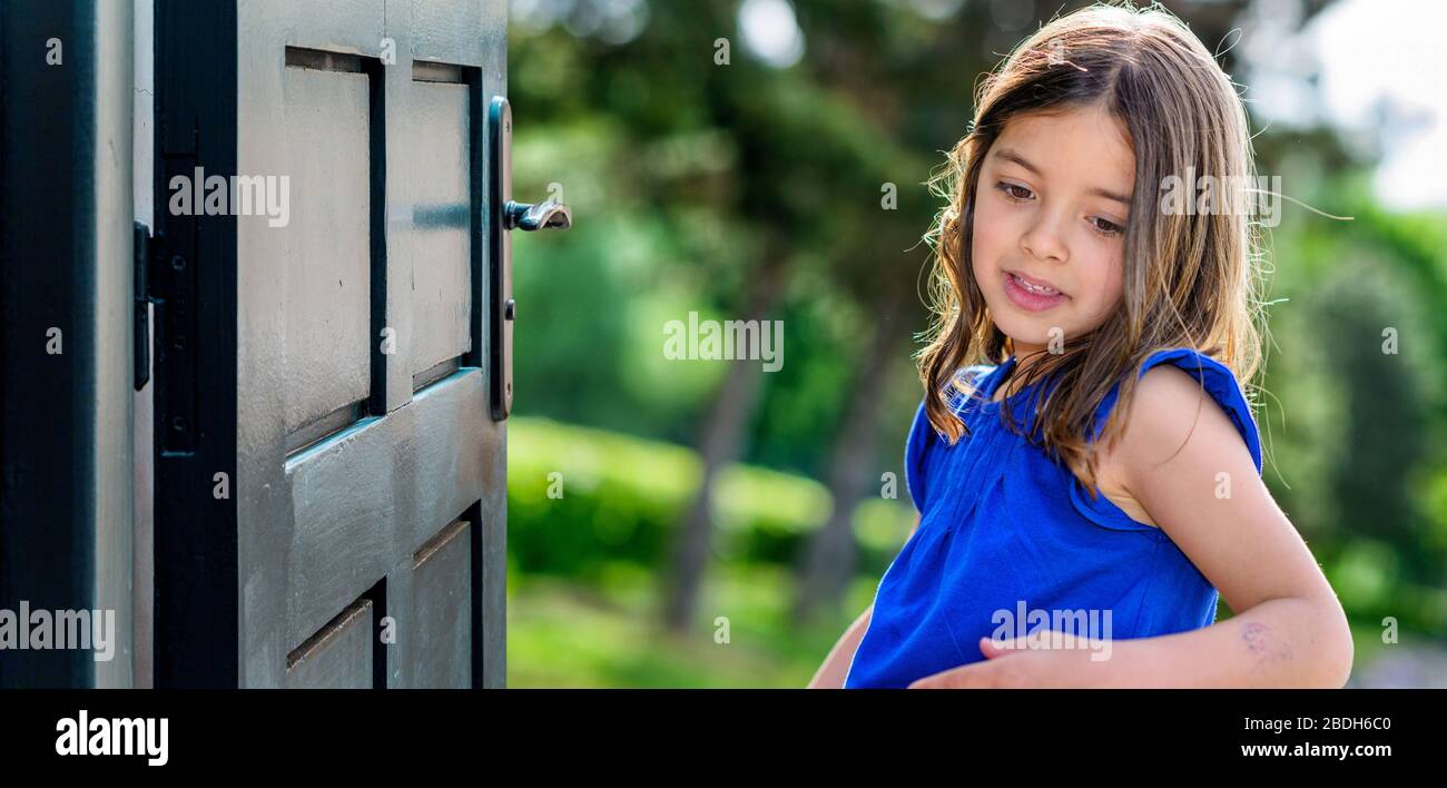 Opened door concept with a pretty young child playing in a playground ...