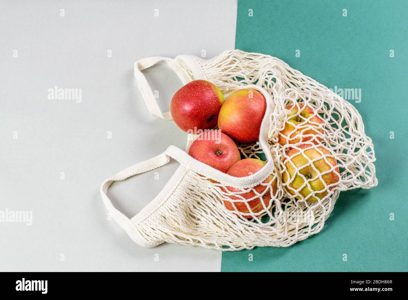 Red apples in the cotton string bag isolated closeup, top view. Healthy ...