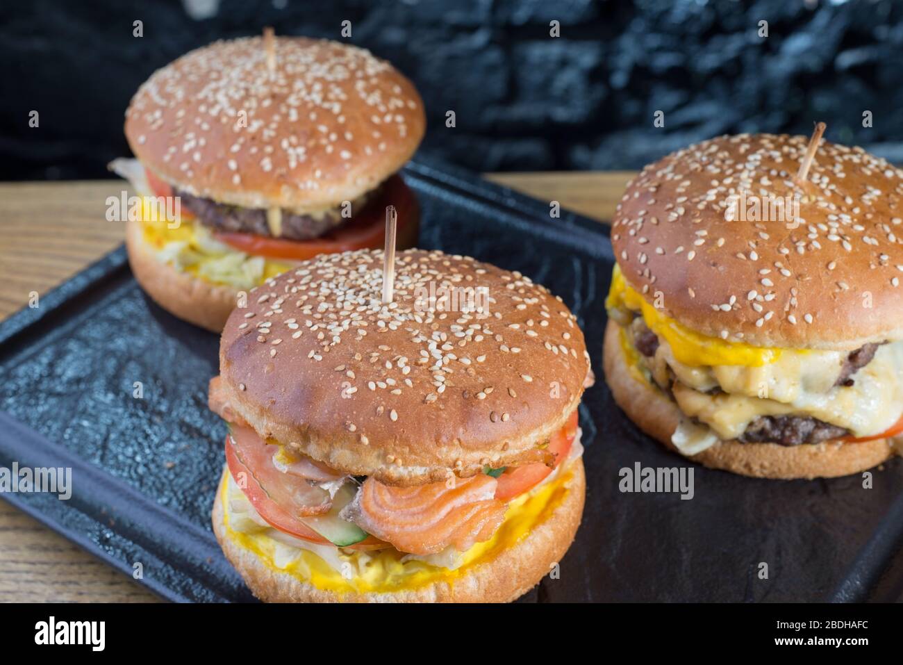 Fresh burger closeup on wooden table. A close-up photograph of the ...