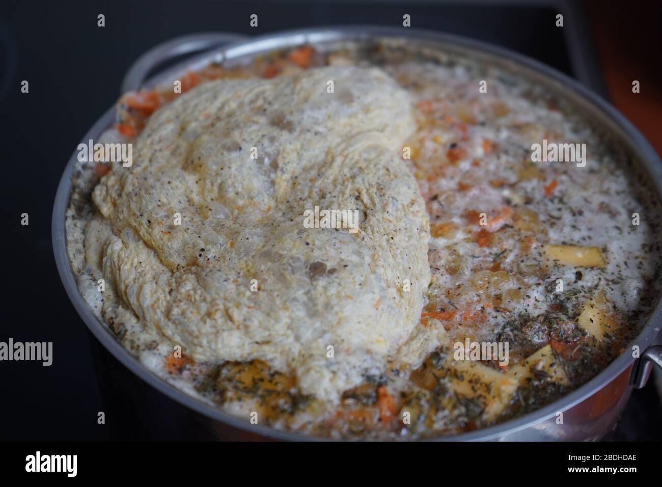 Dirty stuff on the top of boiling peas pot Stock Photo - Alamy