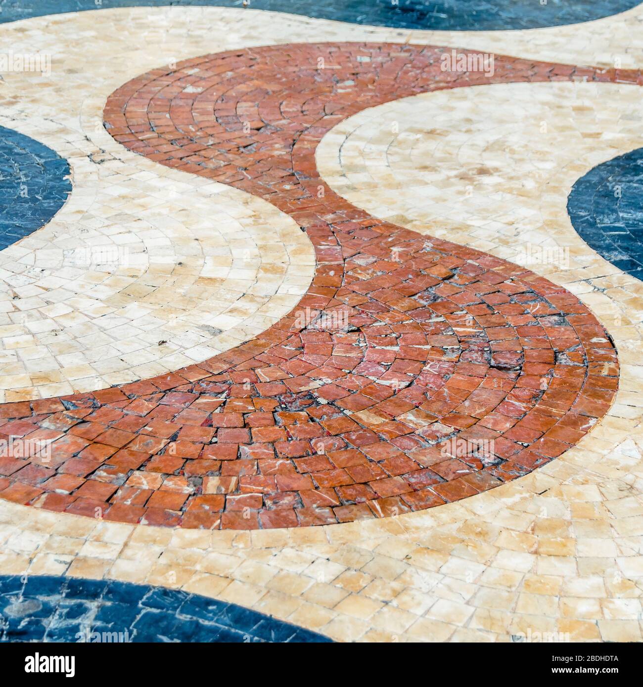 Colorful cobblestone pavement in Alicante, Spain, textured background ...
