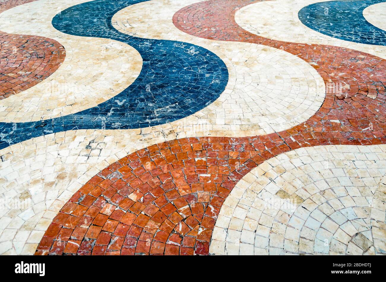 Colorful cobblestone pavement in Alicante, Spain, textured background ...