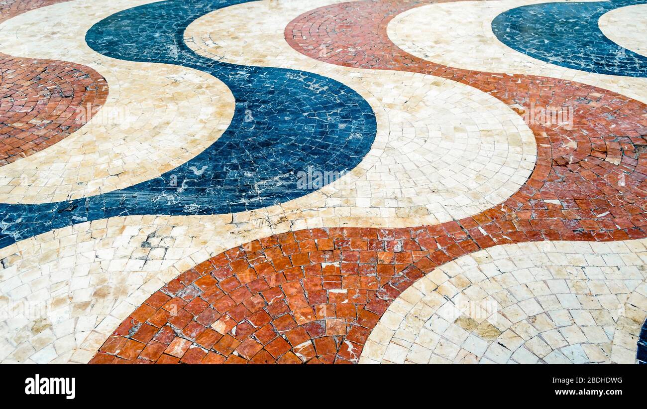 Colorful cobblestone pavement in Alicante, Spain, textured background ...