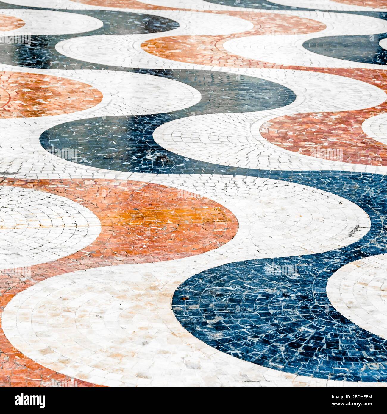 Colorful cobblestone pavement in Alicante, Spain, textured background ...