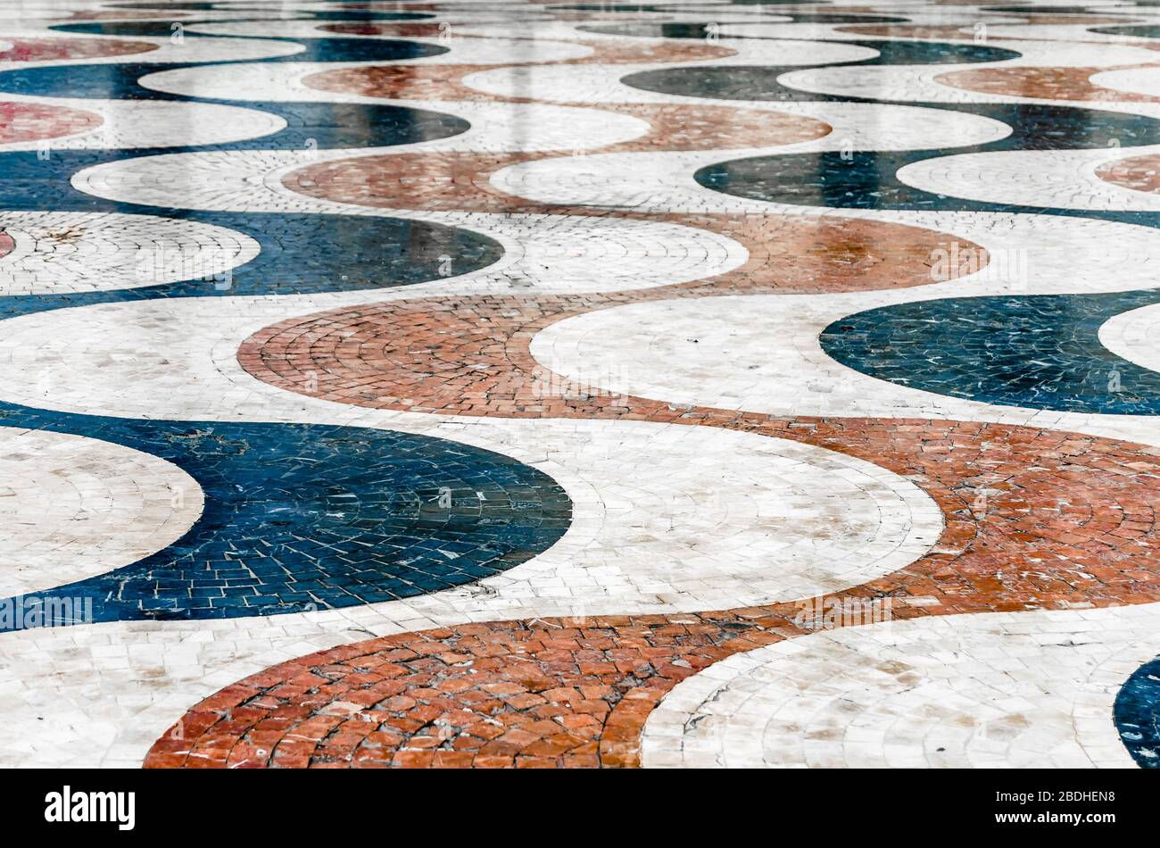 Colorful cobblestone pavement in Alicante, Spain, textured background ...