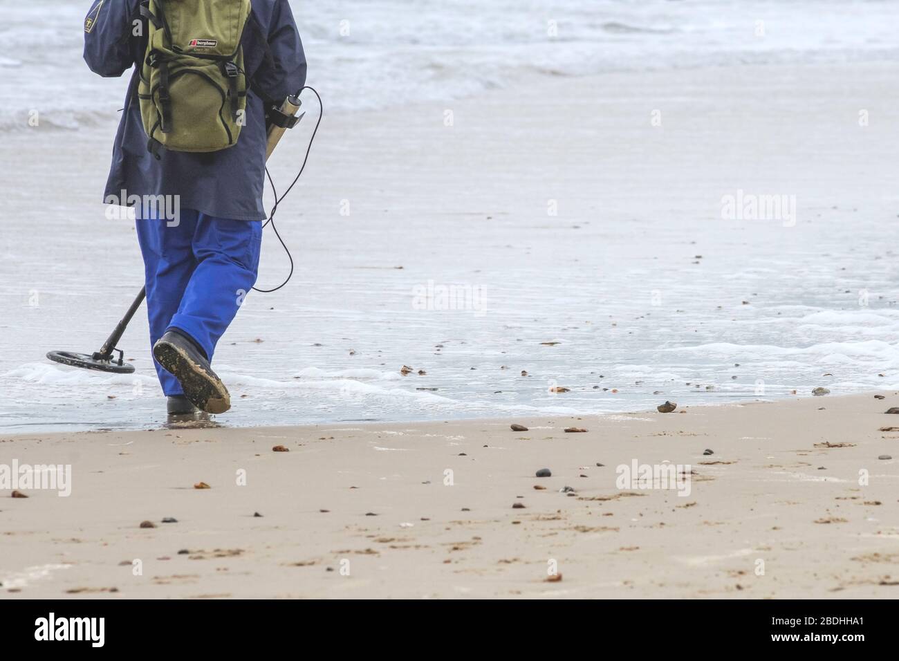 Man using metal detector walks on the beach Stock Photo - Alamy