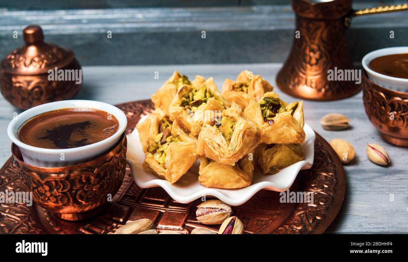 Arabic baklava dessert with coffee in copper cups Stock Photo - Alamy