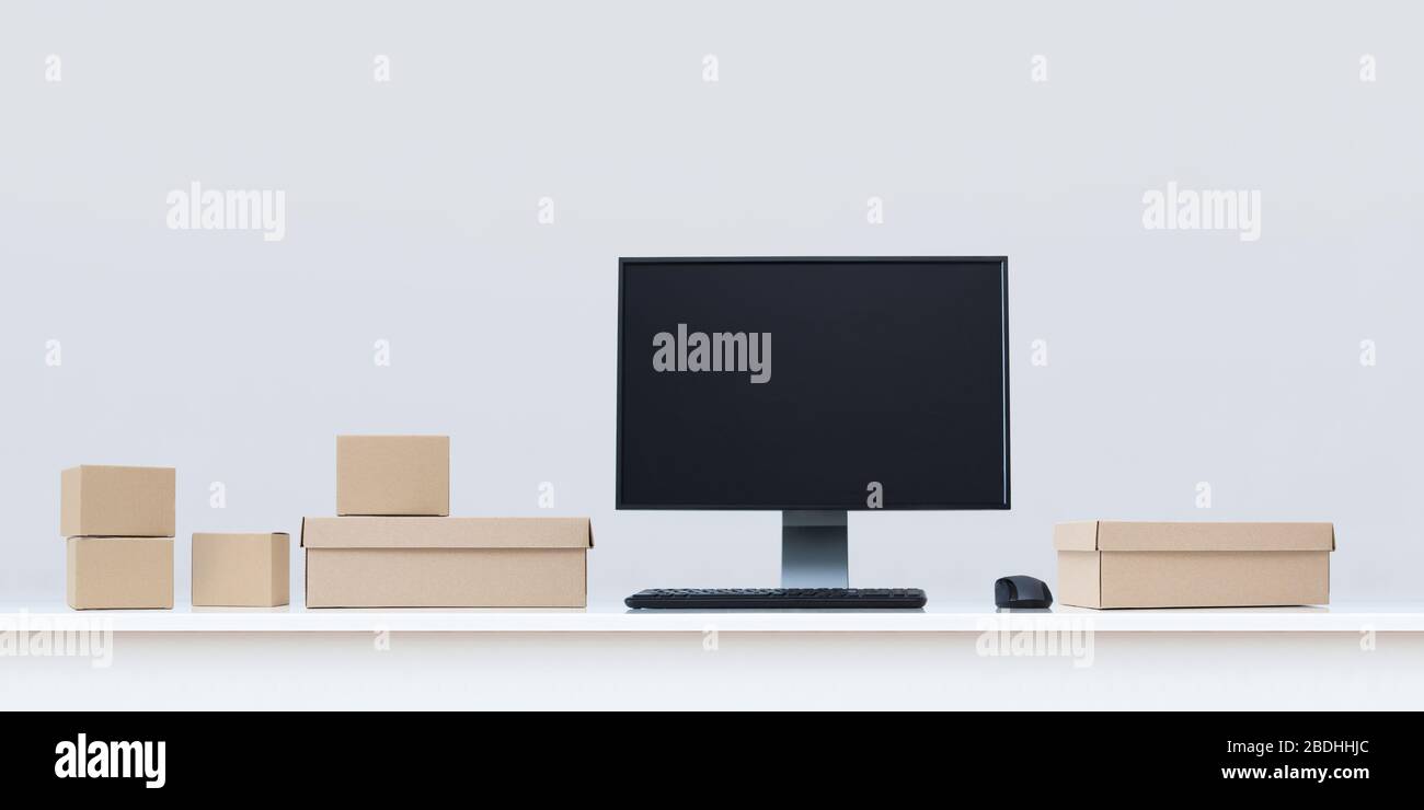 Clean white office desk in with computer and boxes Stock Photo - Alamy