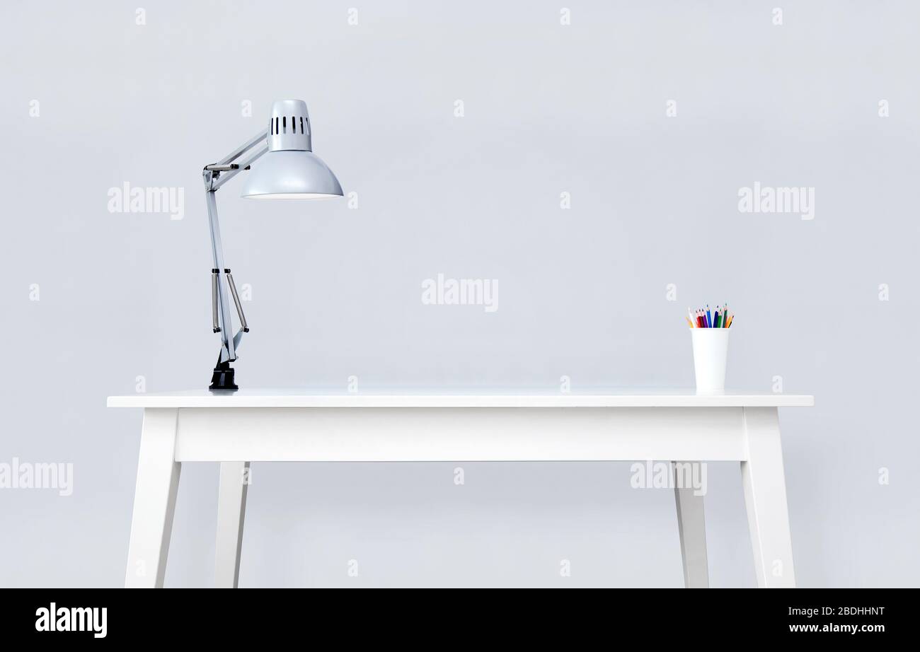 Clean white desk with desk lamp and free space Stock Photo - Alamy