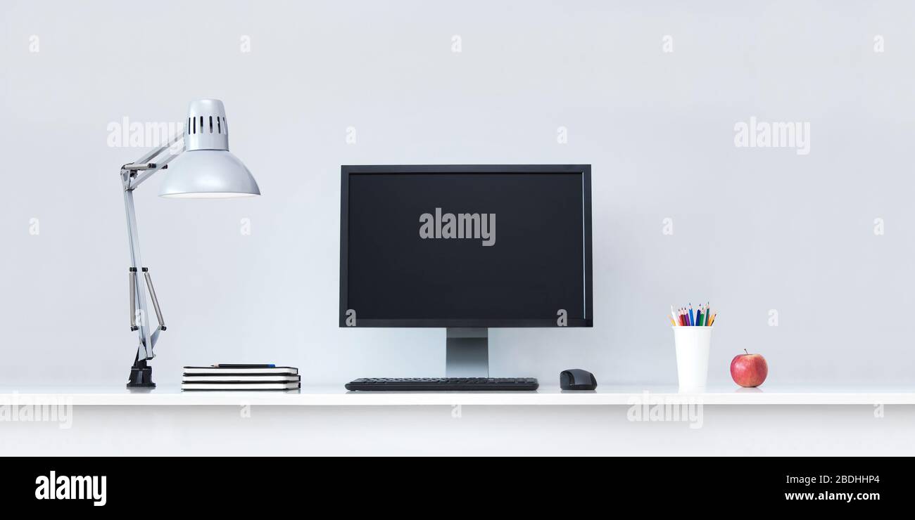 Clean white office desk in with computer and lamp Stock Photo - Alamy