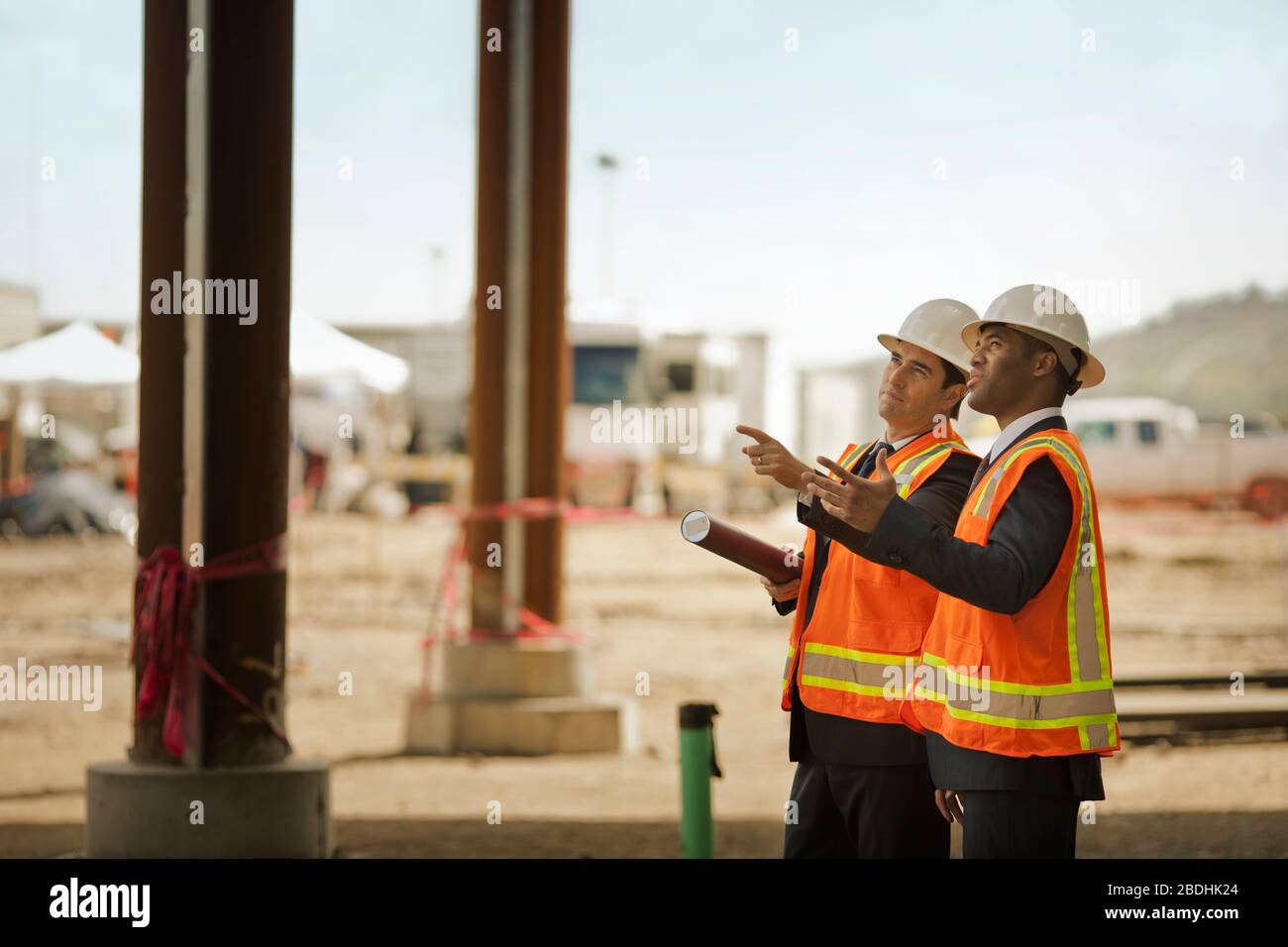 Two business colleagues discussing a project on a construction site ...