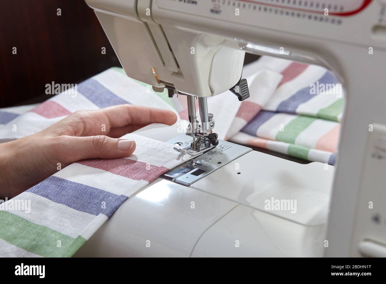Tailoring Process - Women's hands behind her sewing Stock Photo - Alamy