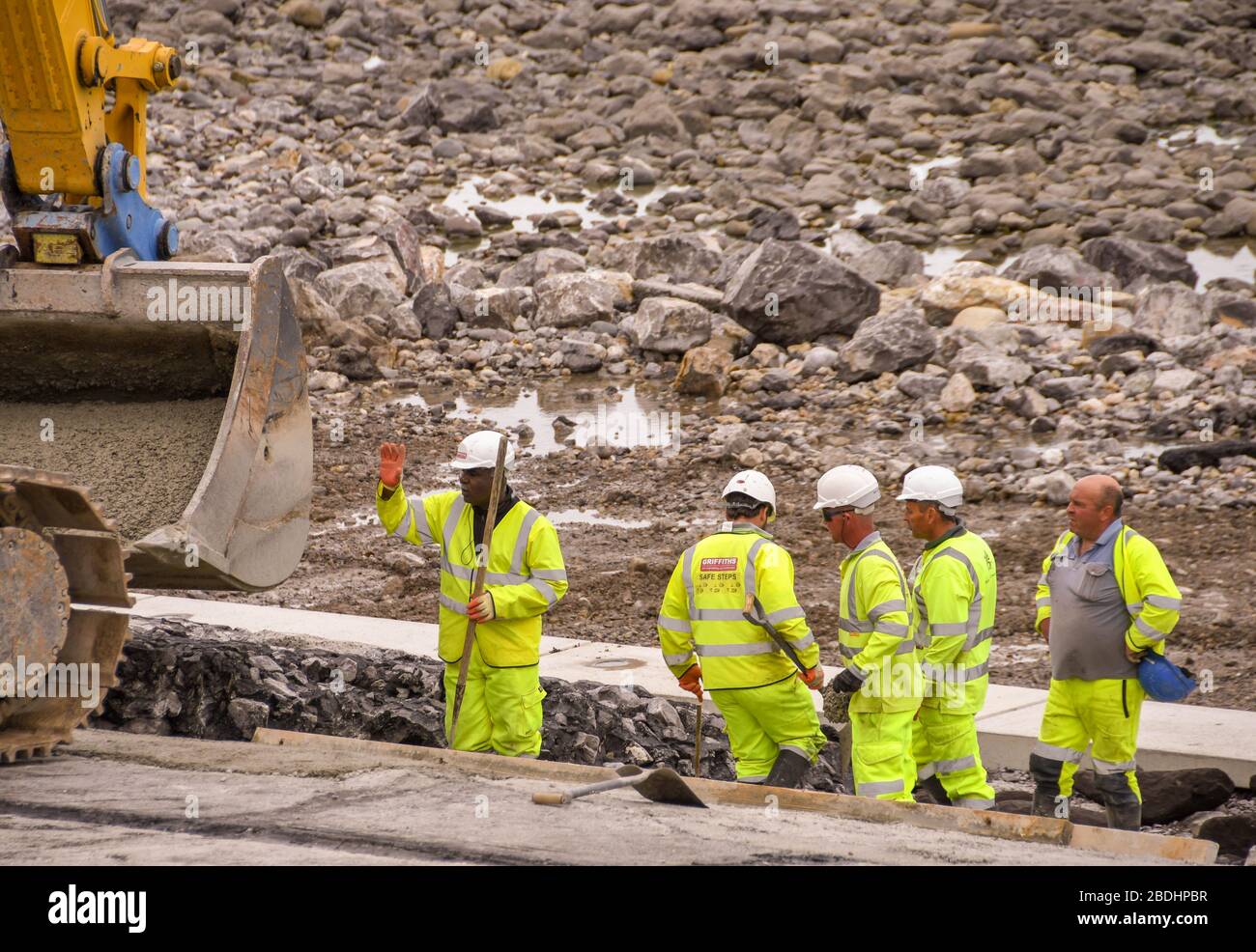 PORTHCAWL, WALES - JUNE 2018: Construction workers laying concrete on ...
