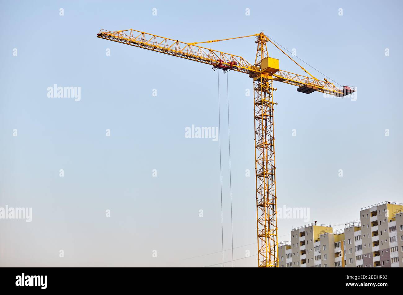 Tower crane building a house. Concrete building under construction ...