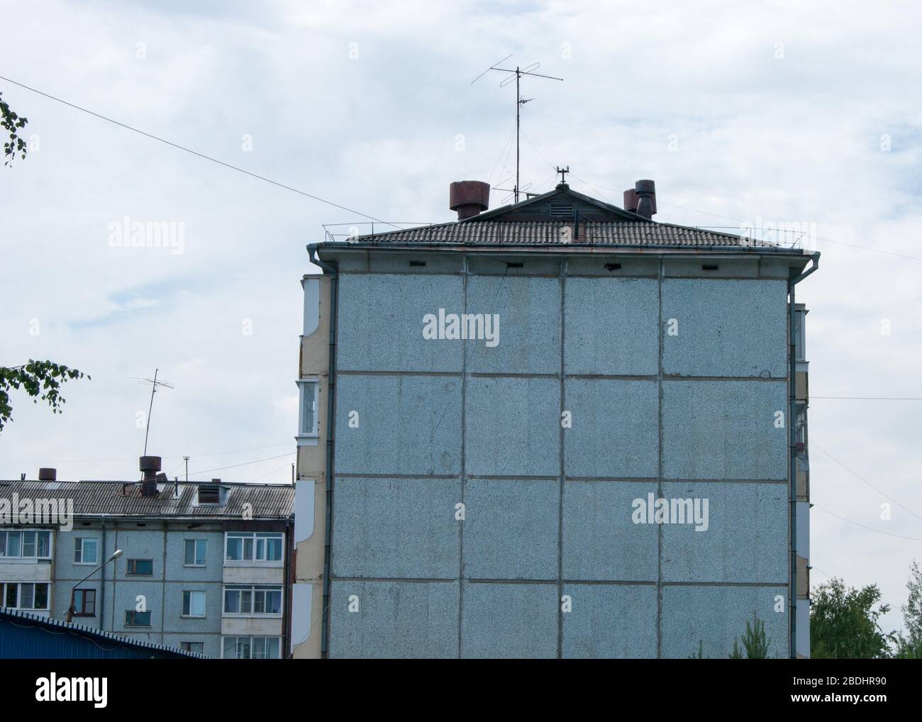 Provincial poor city. In the photo - the blank wall of the panel five ...