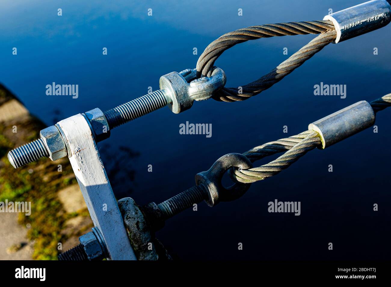 Cable tensioners on a white post Stock Photo - Alamy