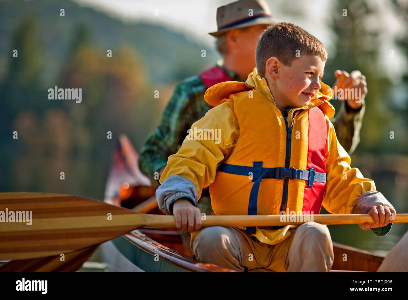 Happy grandfather and young grandson canoeing together on a lake Stock ...