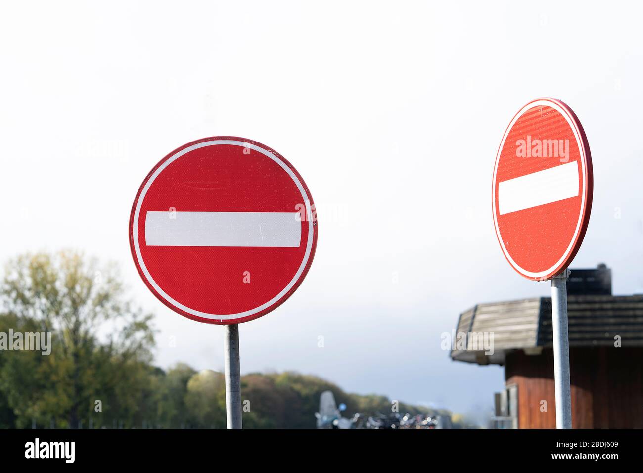 Two red circular traffic signs or roadsign with white bar indicating no ...