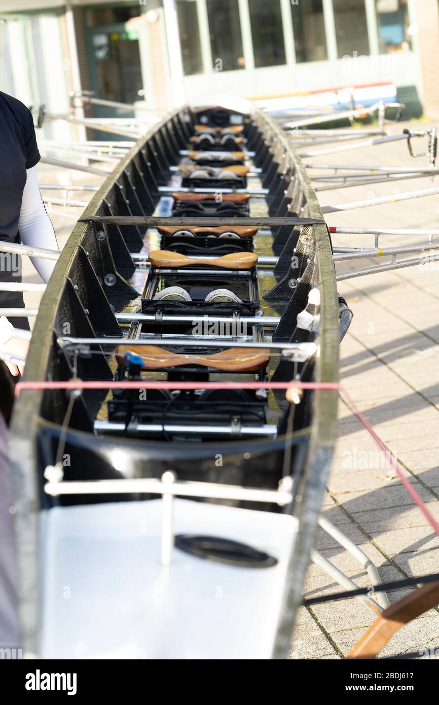 a Look inside a professional carbon fiber rowing boat with seats and ...