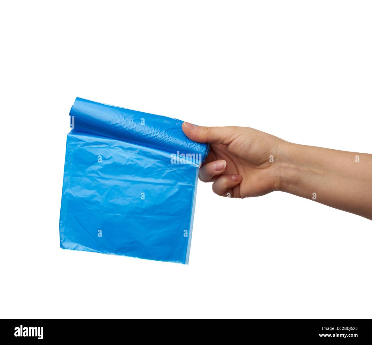 female hand holds a bundle of blue plastic bags for garbage, part of ...