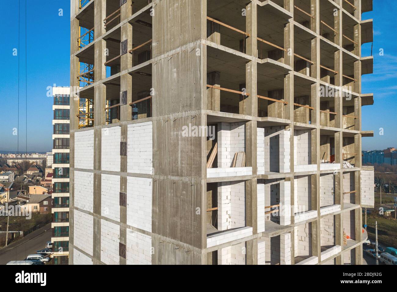 Aerial view of concrete frame of tall apartment building under ...